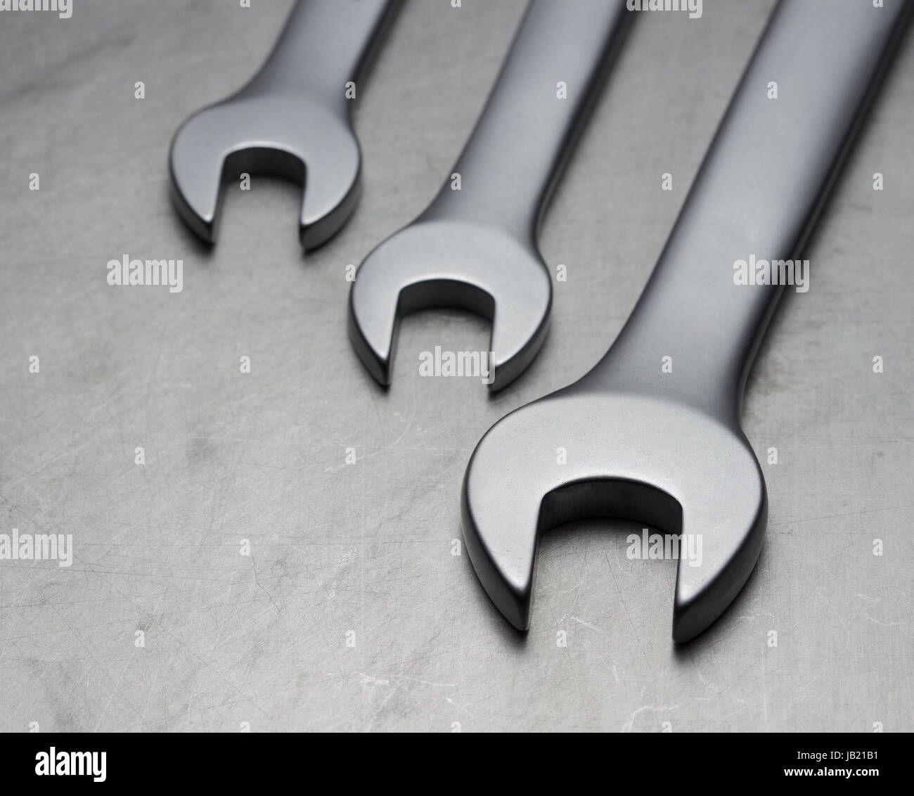 Various spanners on a metal table Stock Photo - Alamy