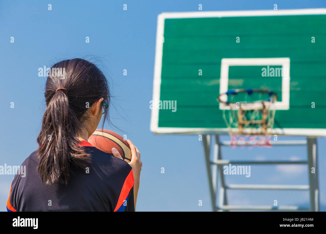female teenager getting ready to shoot a free throw basketball at an ...