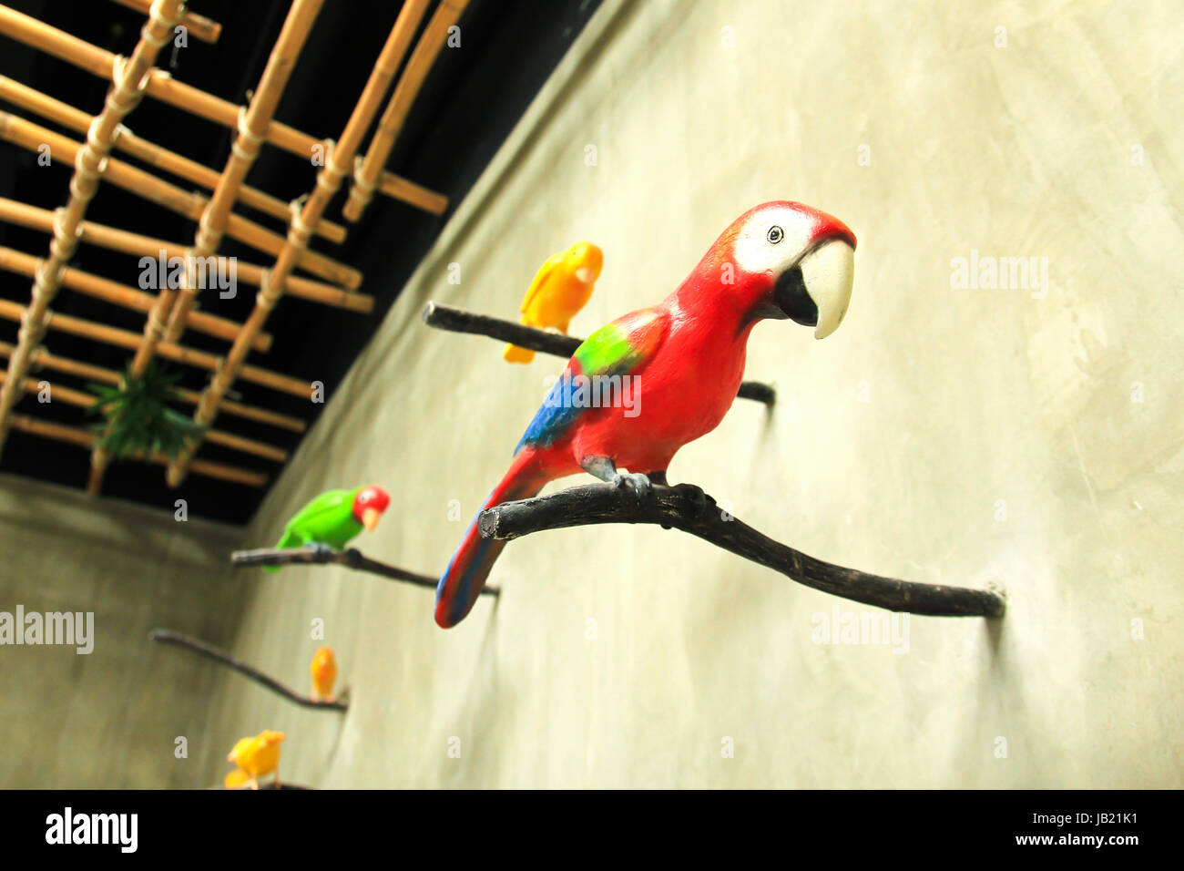 Bird sculpture colorful on wall Stock Photo - Alamy