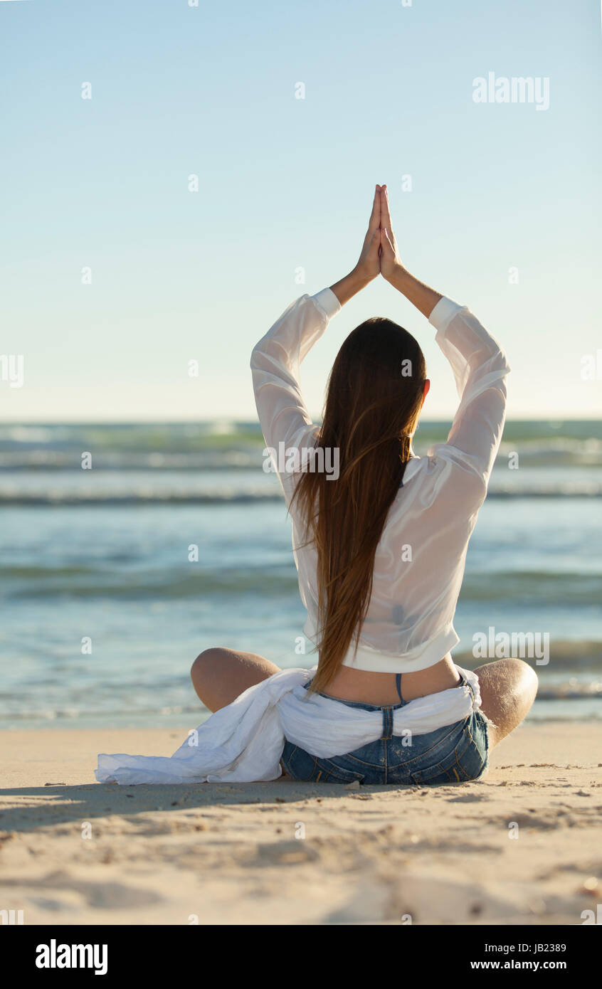 Frau macht Yoga am Strand Stock Photo - Alamy