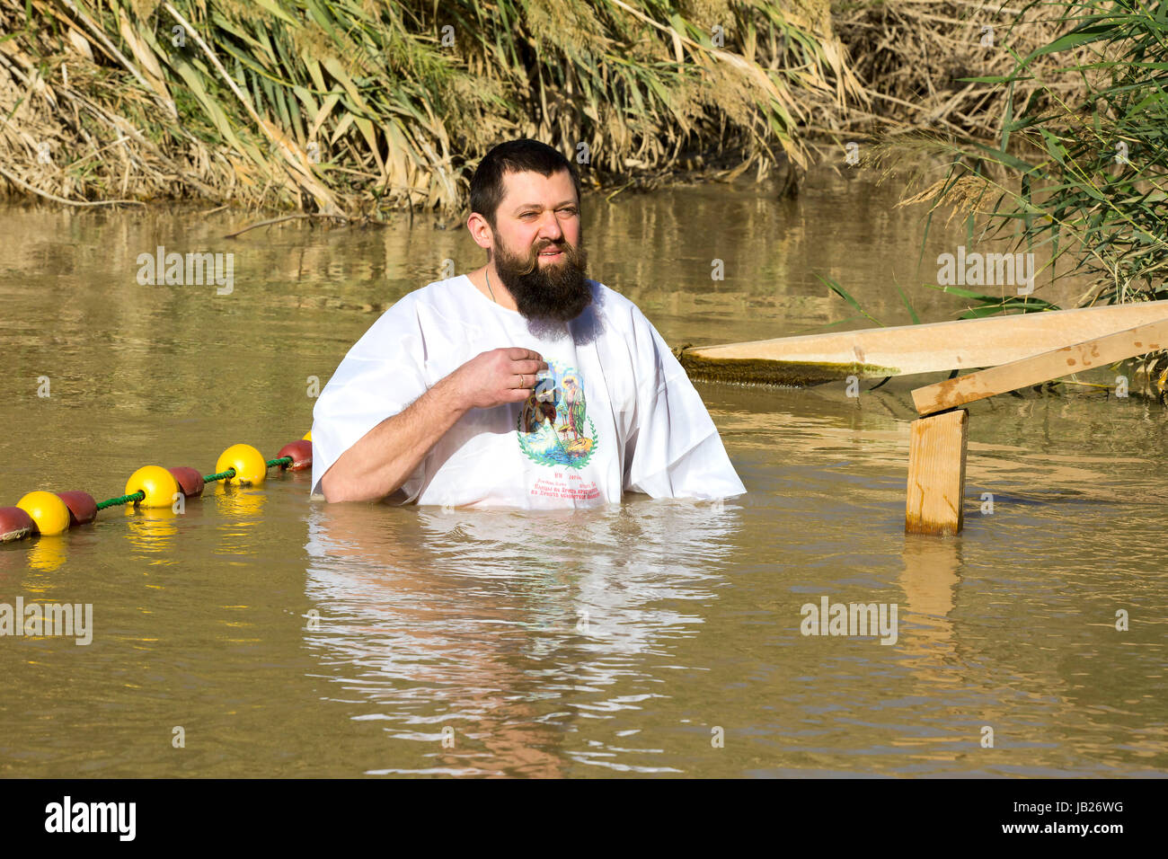 BETHABARA, JORDAN - JANUARY - 11, 2017: Man middle-aged pilgrim passes ...