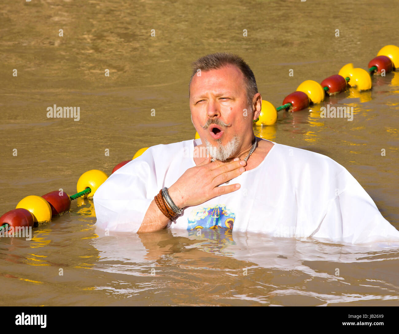 BETHABARA, JORDAN - JANUARY - 11, 2017: Man middle-aged pilgrim passes ...