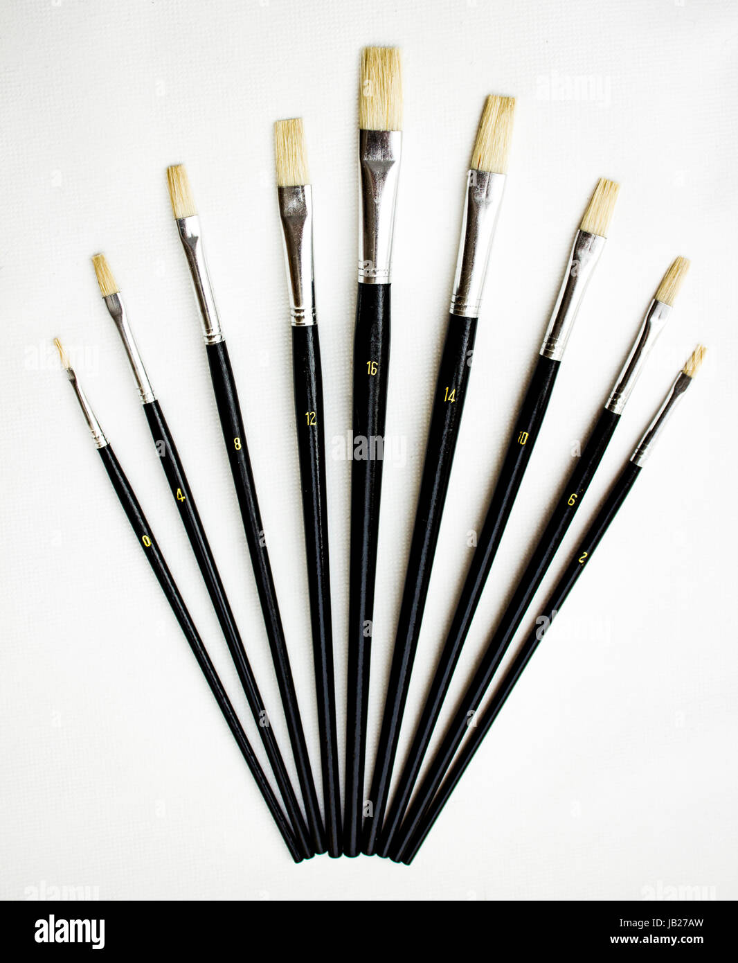 Different sized brushes on a white background Stock Photo - Alamy
