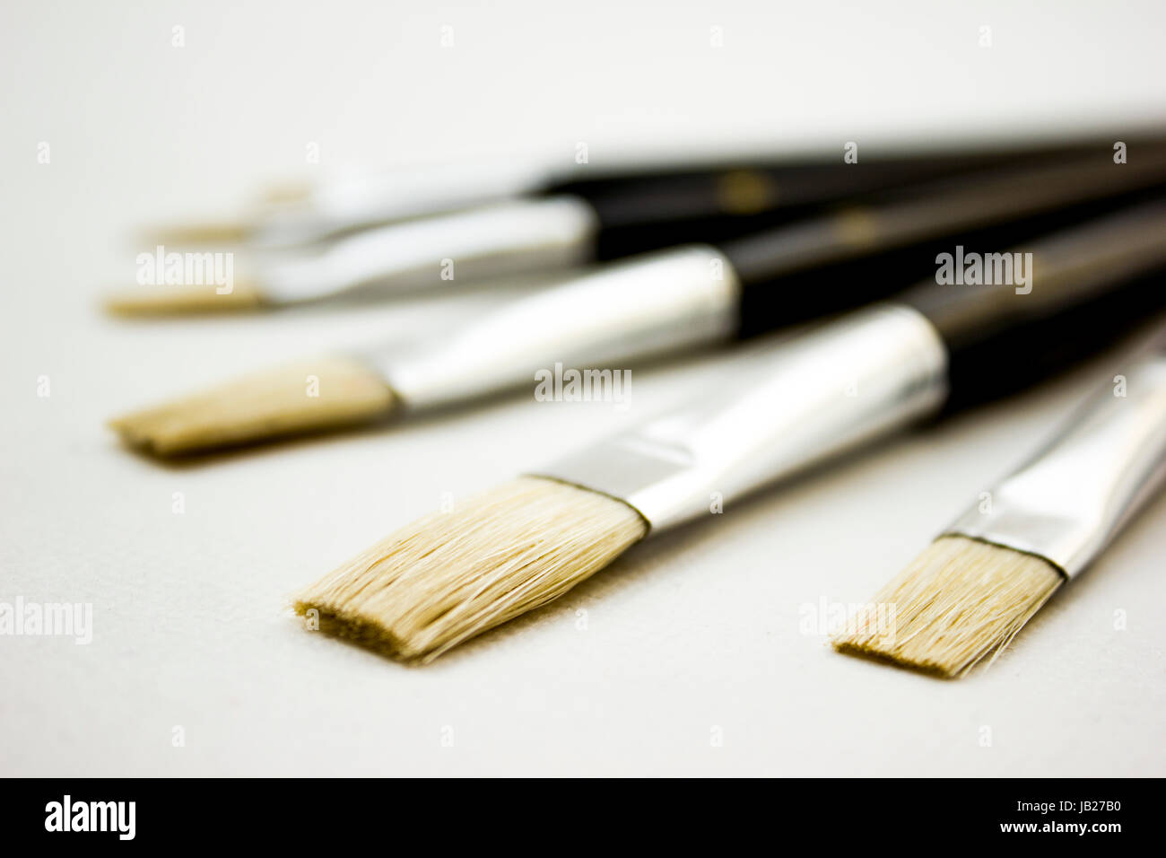 Different sized brushes on a white background Stock Photo - Alamy