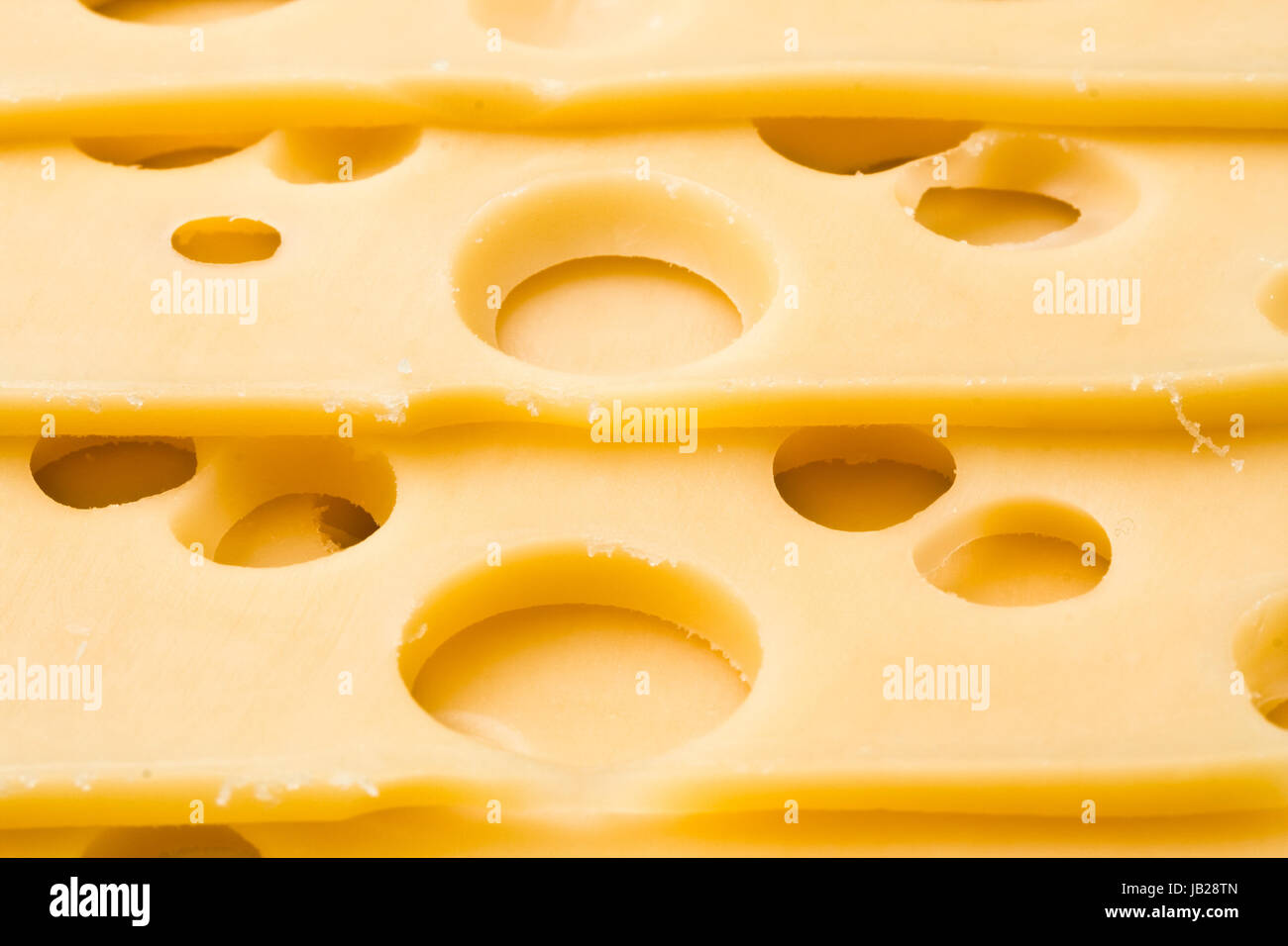 Holes in cheese, close up Stock Photo - Alamy