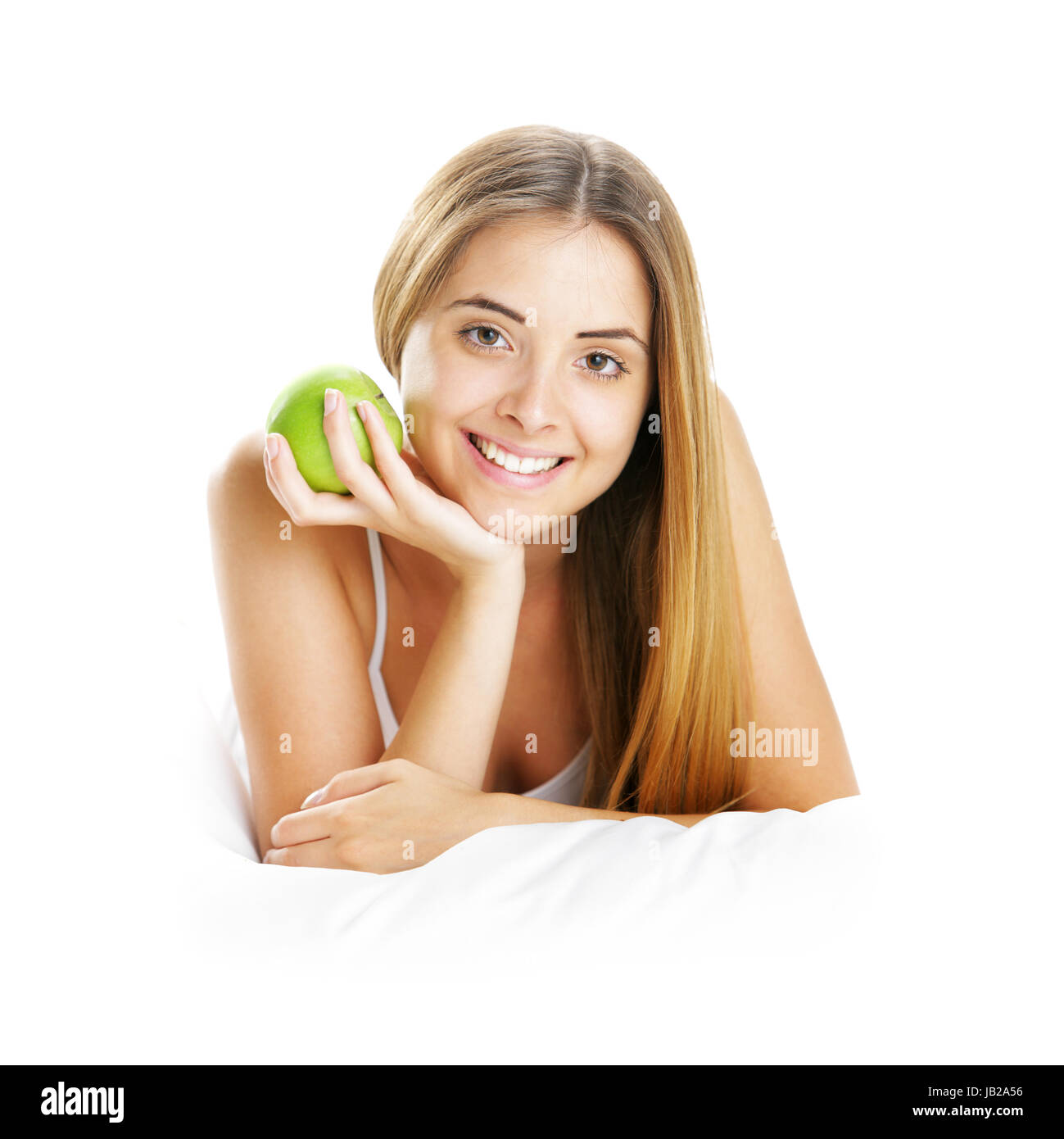 Smiling Young Woman Holding Apple in Bed Stock Photo - Alamy