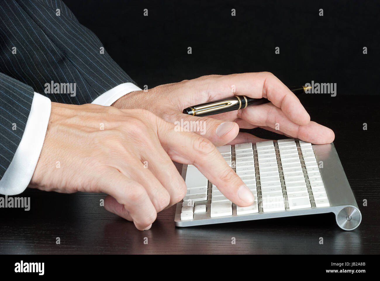 Close-up of a businessman pushing enter on a computer keyboard Stock ...