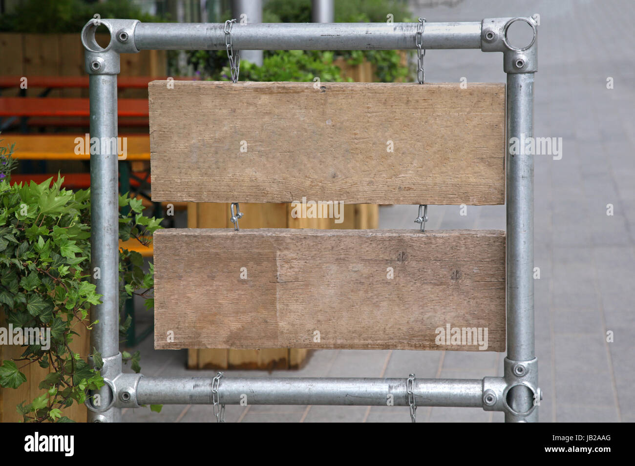 Retro wooden sign panel on metal frame on street Stock Photo - Alamy