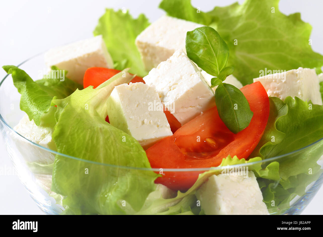 Diced feta cheese with fresh vegetable salad Stock Photo - Alamy