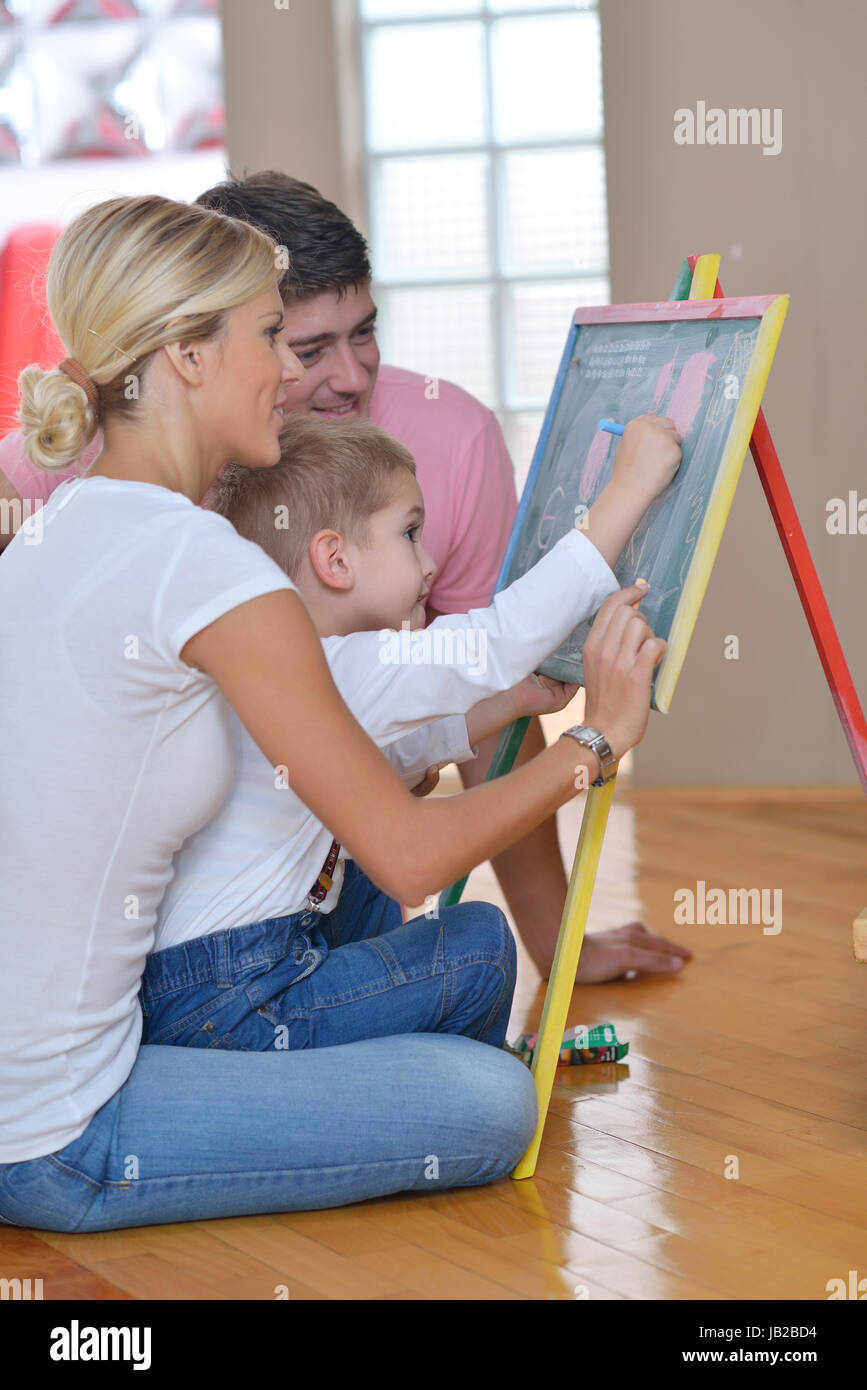 happy young family teach leassons and prepare their son for school ...
