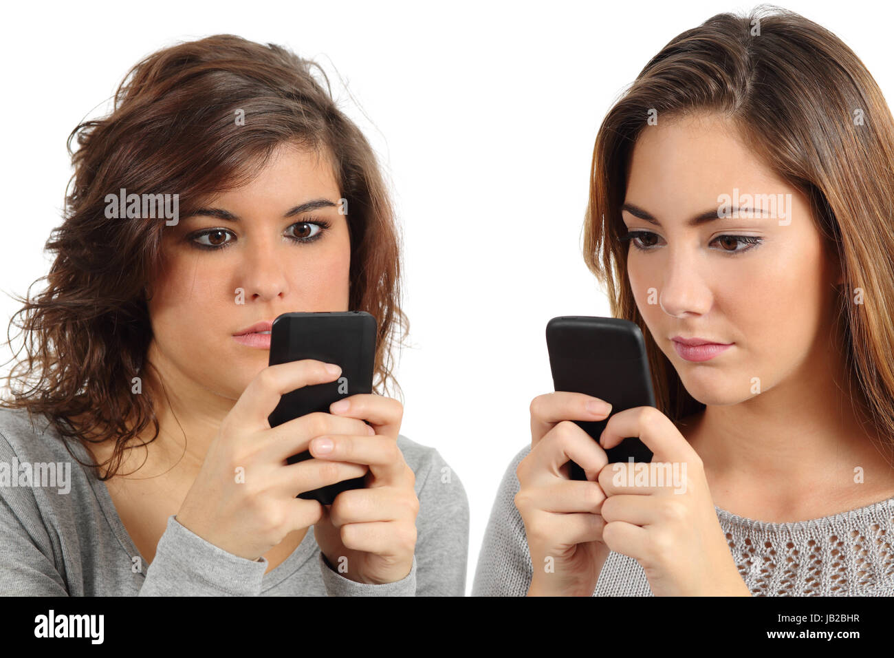 Two teenagers addicted to the smart phone technology isolated on a ...