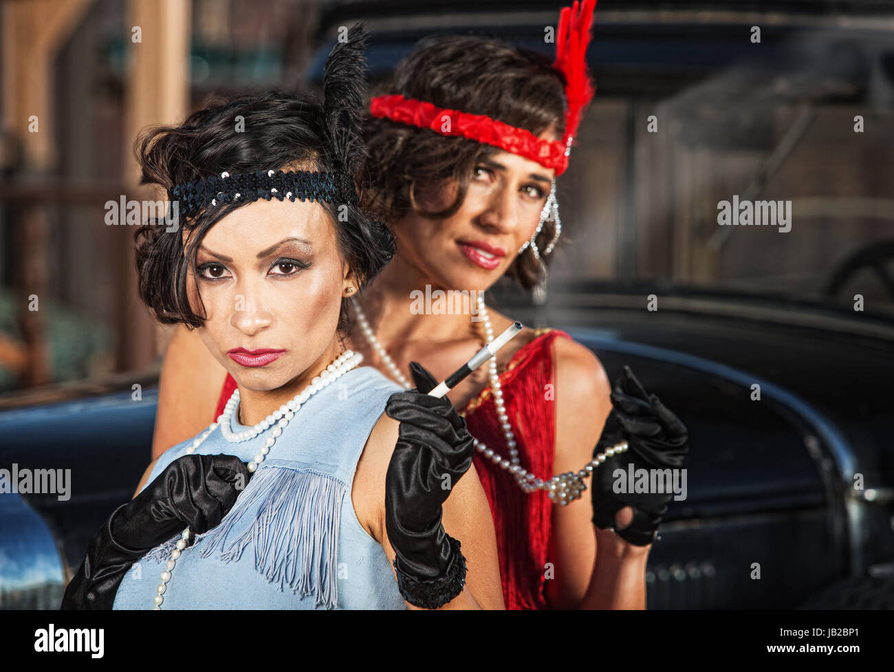 Serious Hispanic flapper ladies with pearl necklaces Stock Photo - Alamy