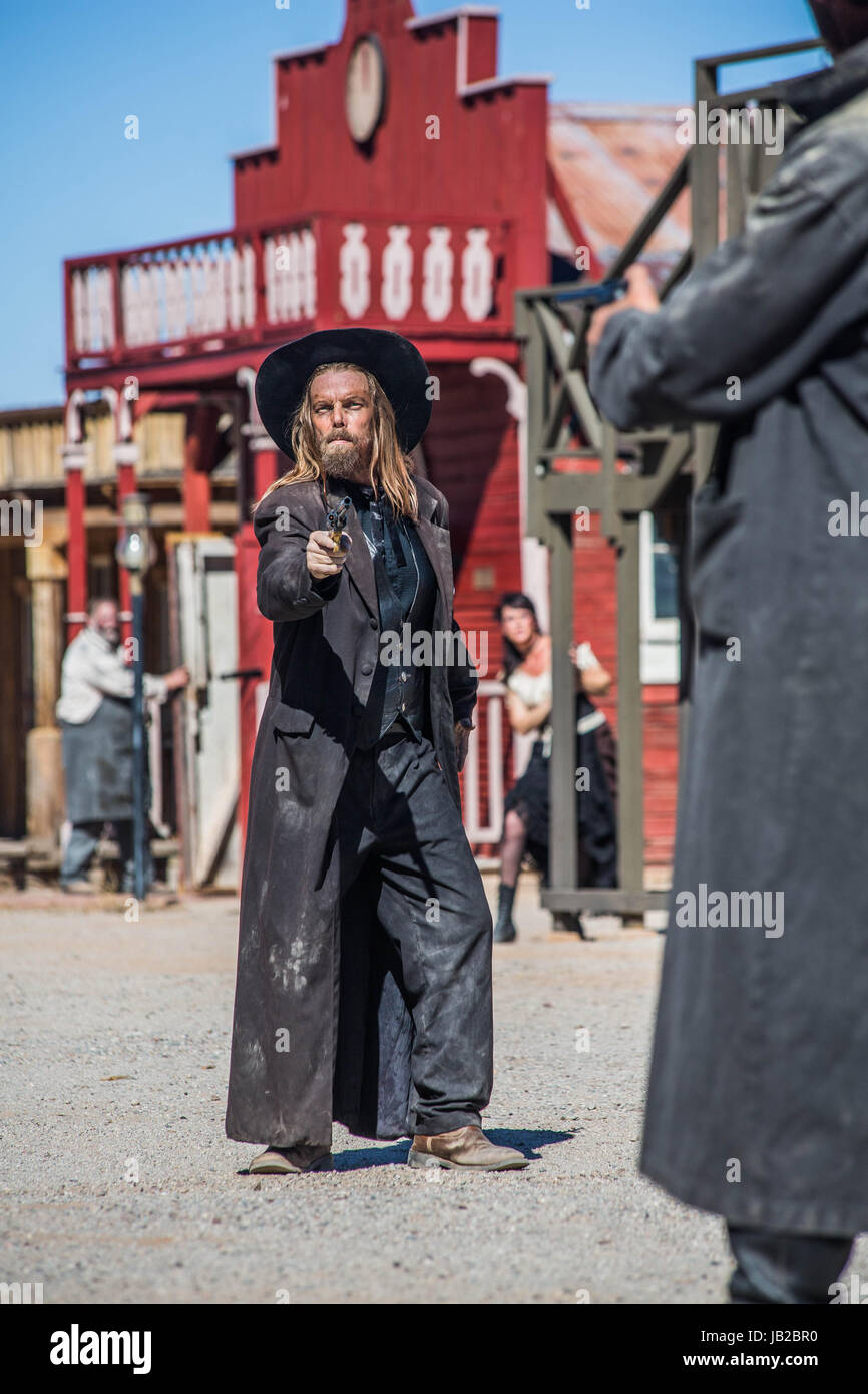 Two Cowboys Draw Weapons on Each Other in a Duel Stock Photo - Alamy