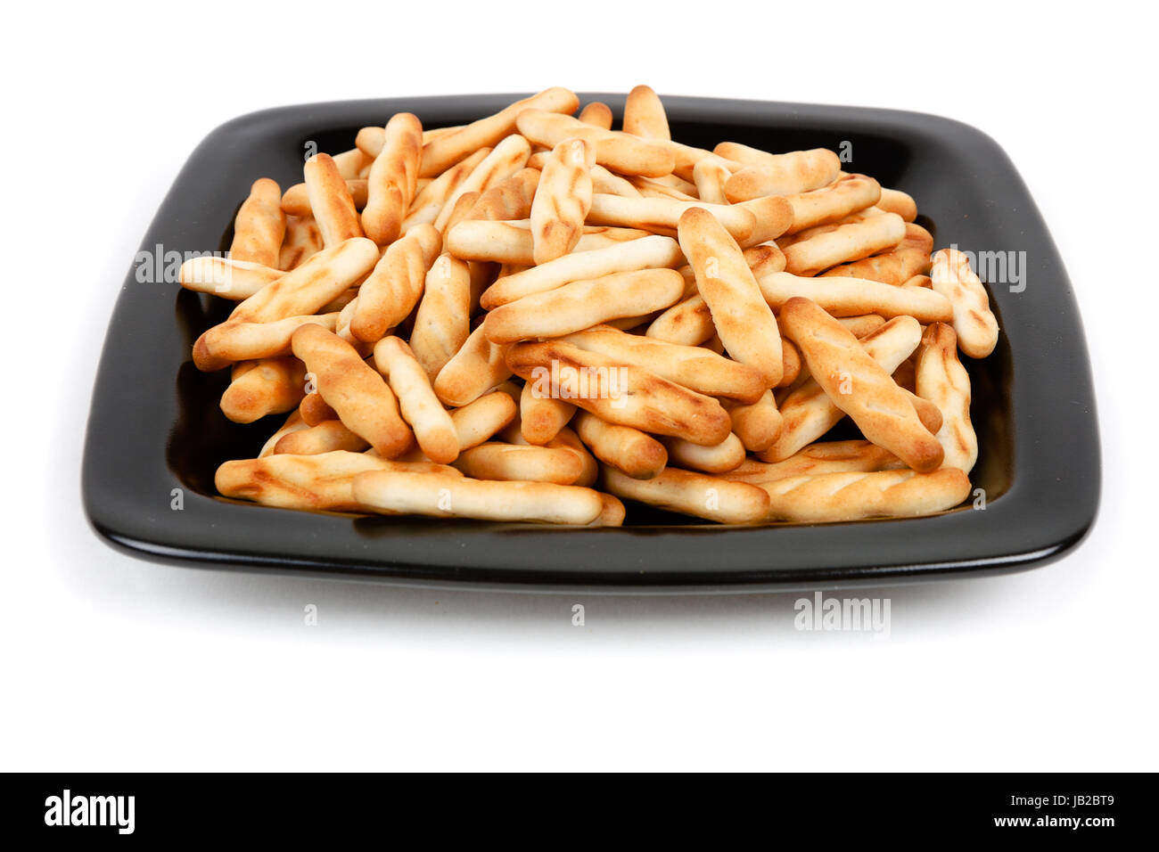 Diner cookies on a square black plate Stock Photo - Alamy