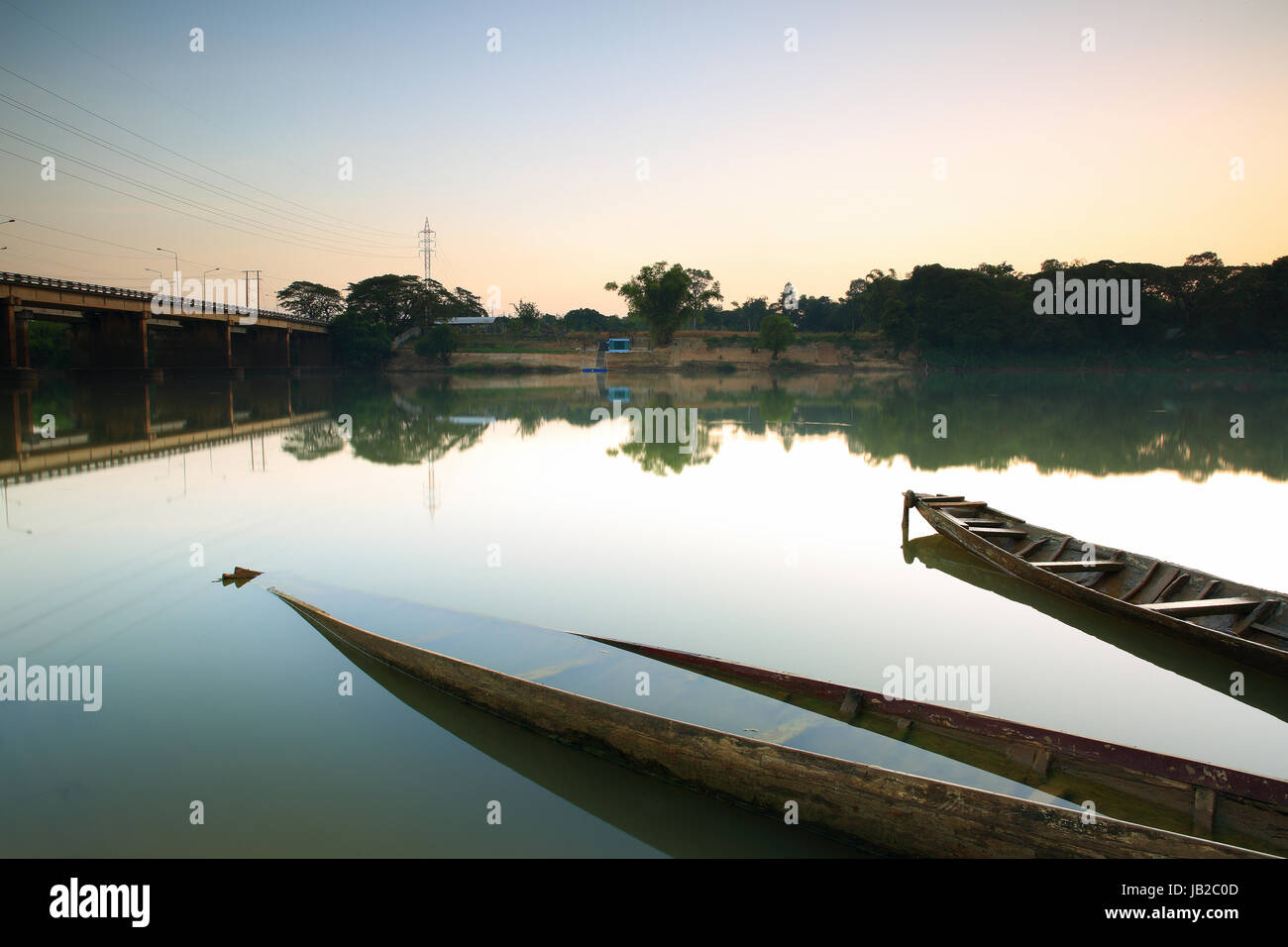 Fishing boat on the “Moon River” in Thailand after sunset Stock Photo ...