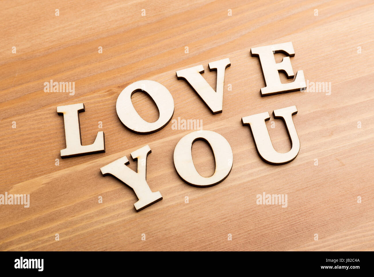 Wooden texture letters forming with phrase Love You Stock Photo - Alamy