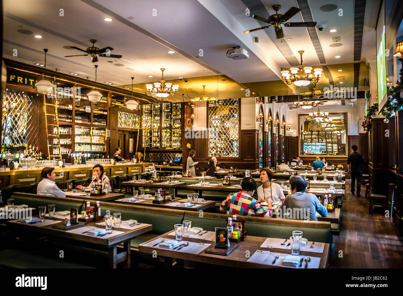 European bistro interior with table settings and chandeliers and ...