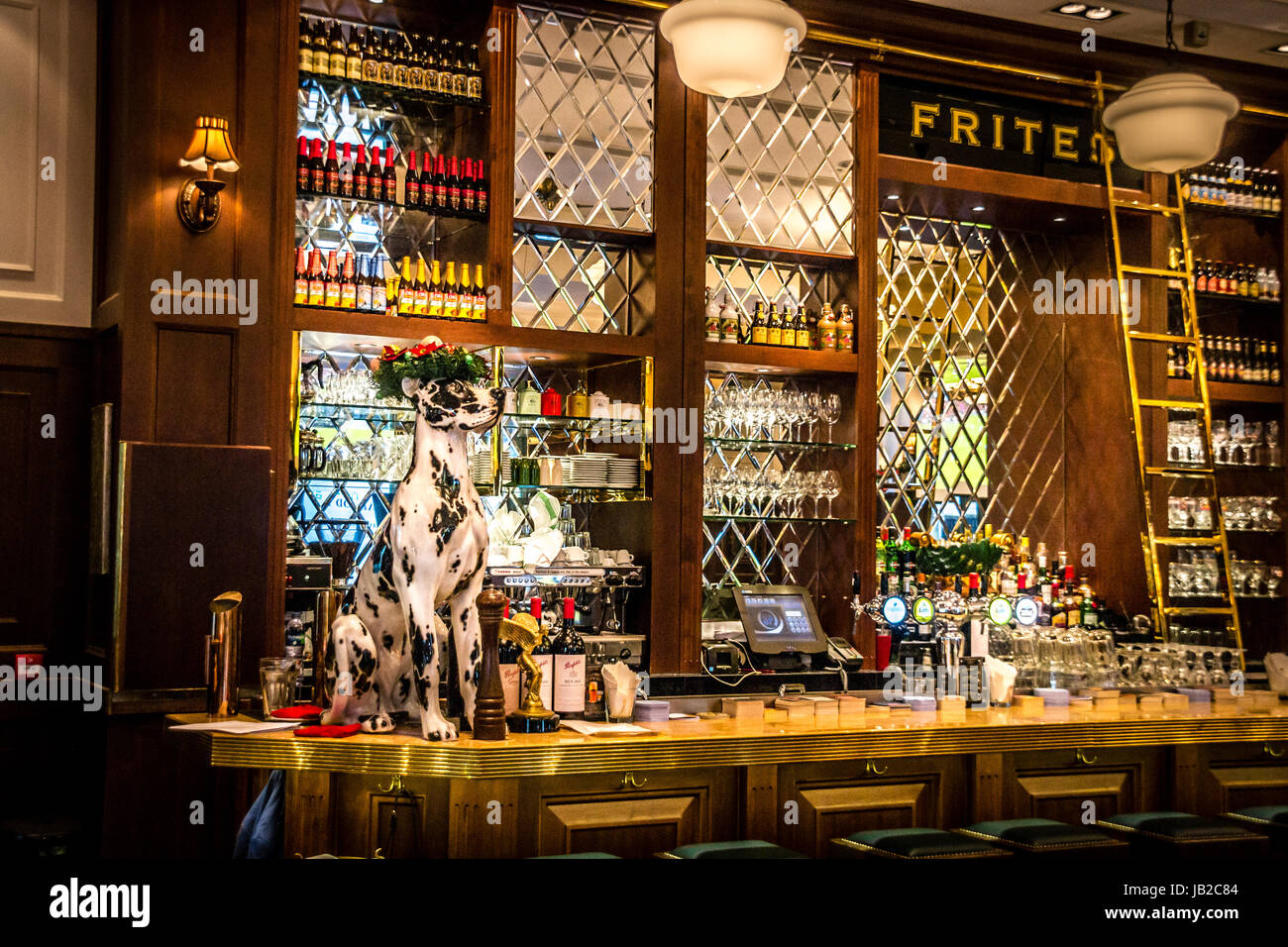 European bistro interior with table settings and chandeliers and ...