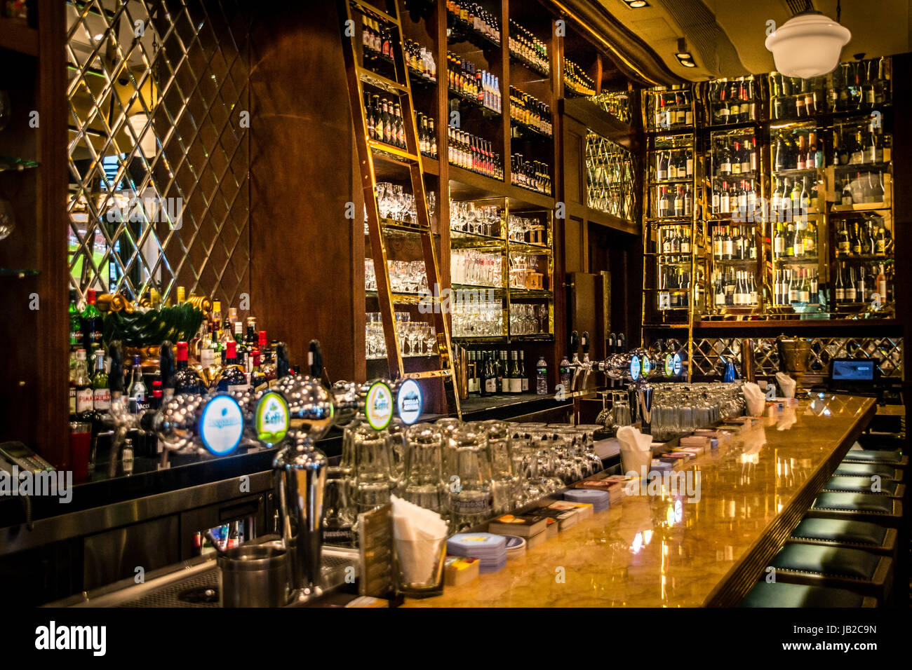 European bistro interior with table settings and chandeliers and ...