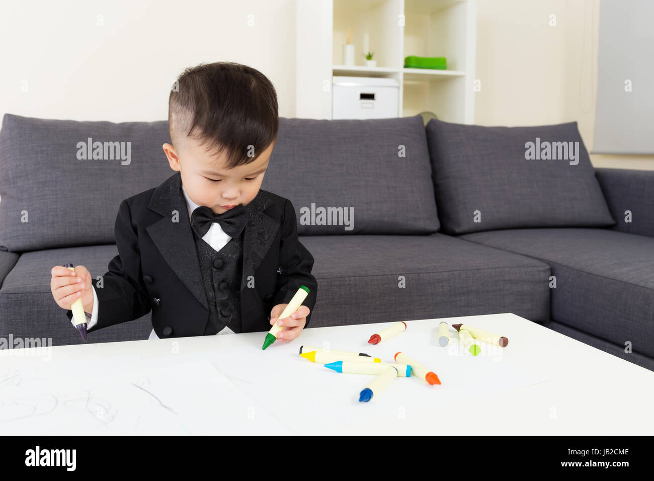Baby boy concentration on drawing Stock Photo - Alamy