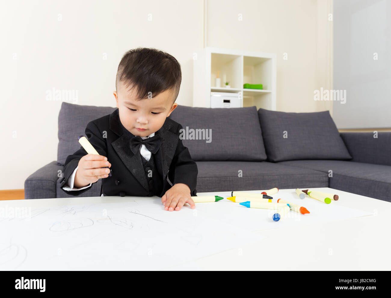 Baby boy concentration on drawing Stock Photo - Alamy