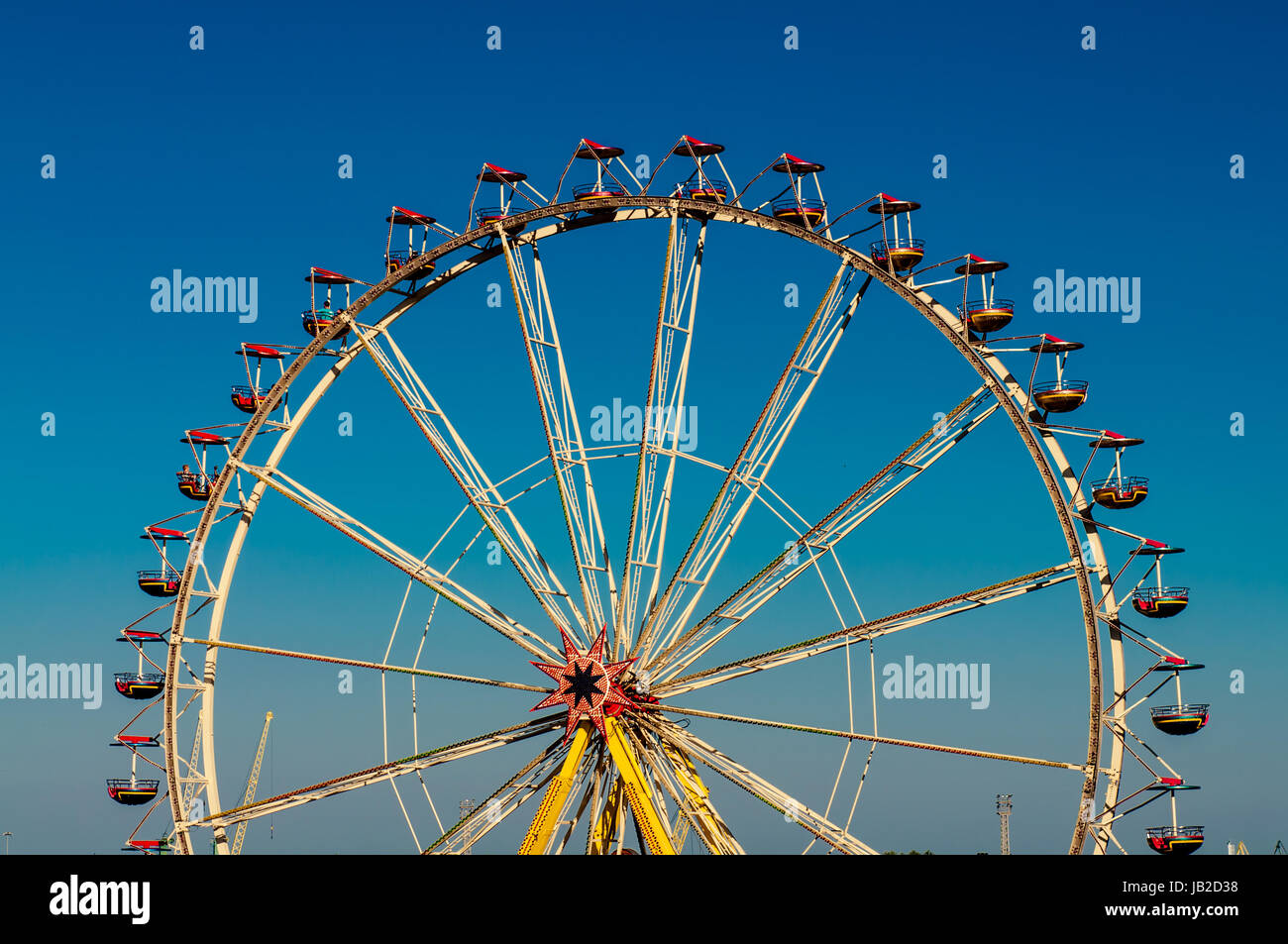 big wheel with multicolored cabins in amusement park Stock Photo - Alamy