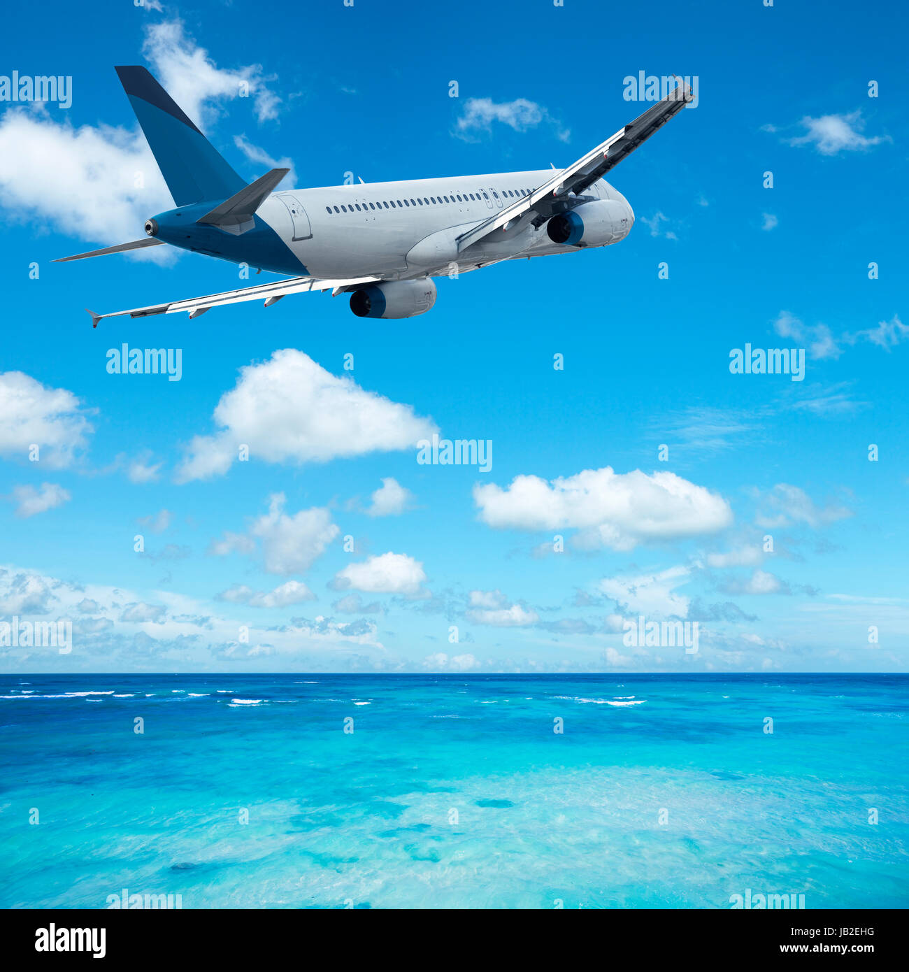 Jet over the tropical sea Stock Photo - Alamy