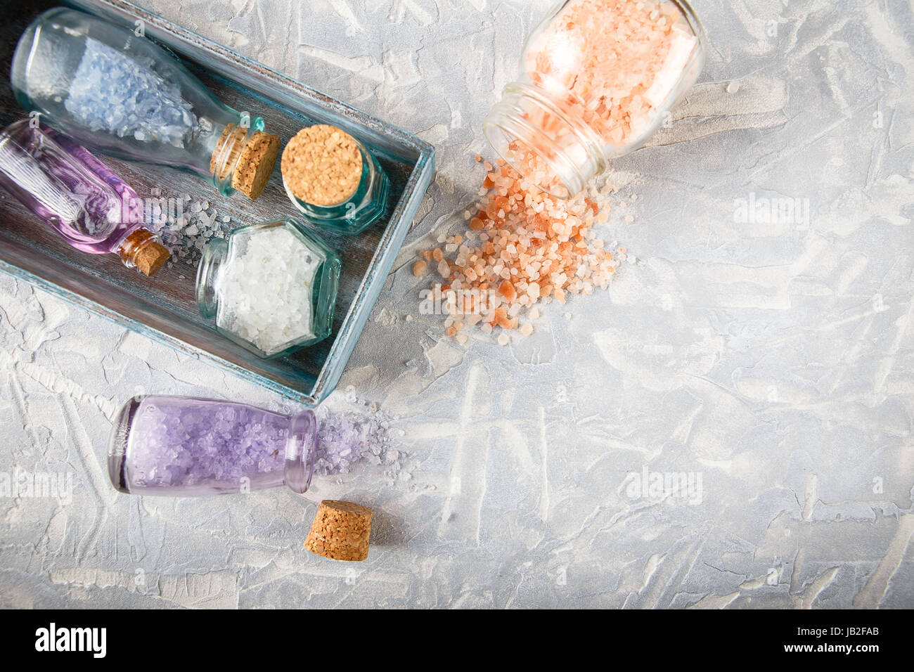 Small glass bottles with aromatic salt. Set for aromatherapy in a ...