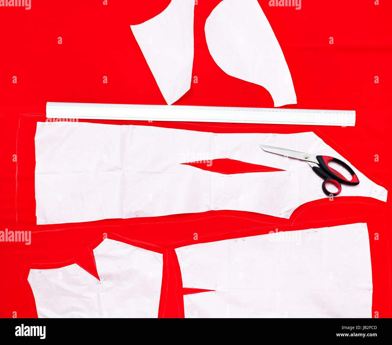 tailor scissors and cutting out woolen fabric along pattern lines for ...