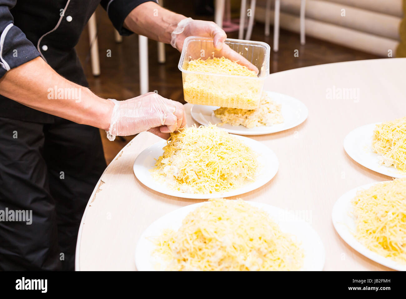 Close-up of chef cooking food kitchen restaurant cutting cook hands ...