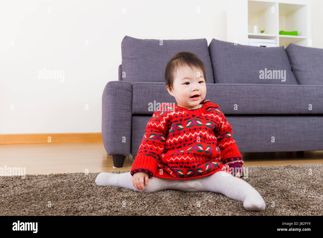 Baby girl doing legs splits on carpet Stock Photo - Alamy