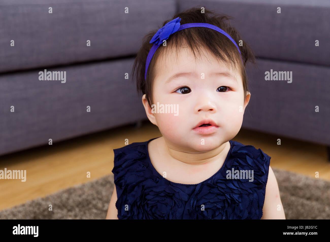 Little baby girl with curiosity expression Stock Photo - Alamy