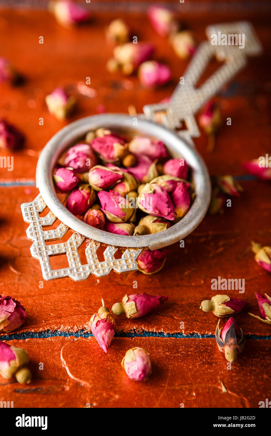 Dry rose buds in a small metal strainer. Rose tea. Top view Stock Photo ...