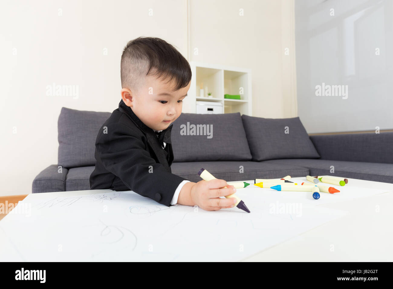 Little boy focus on drawing picture at home Stock Photo - Alamy