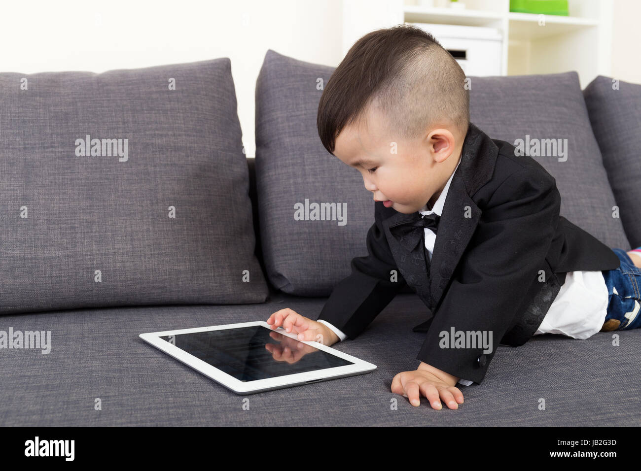 Little boy using tablet Stock Photo - Alamy