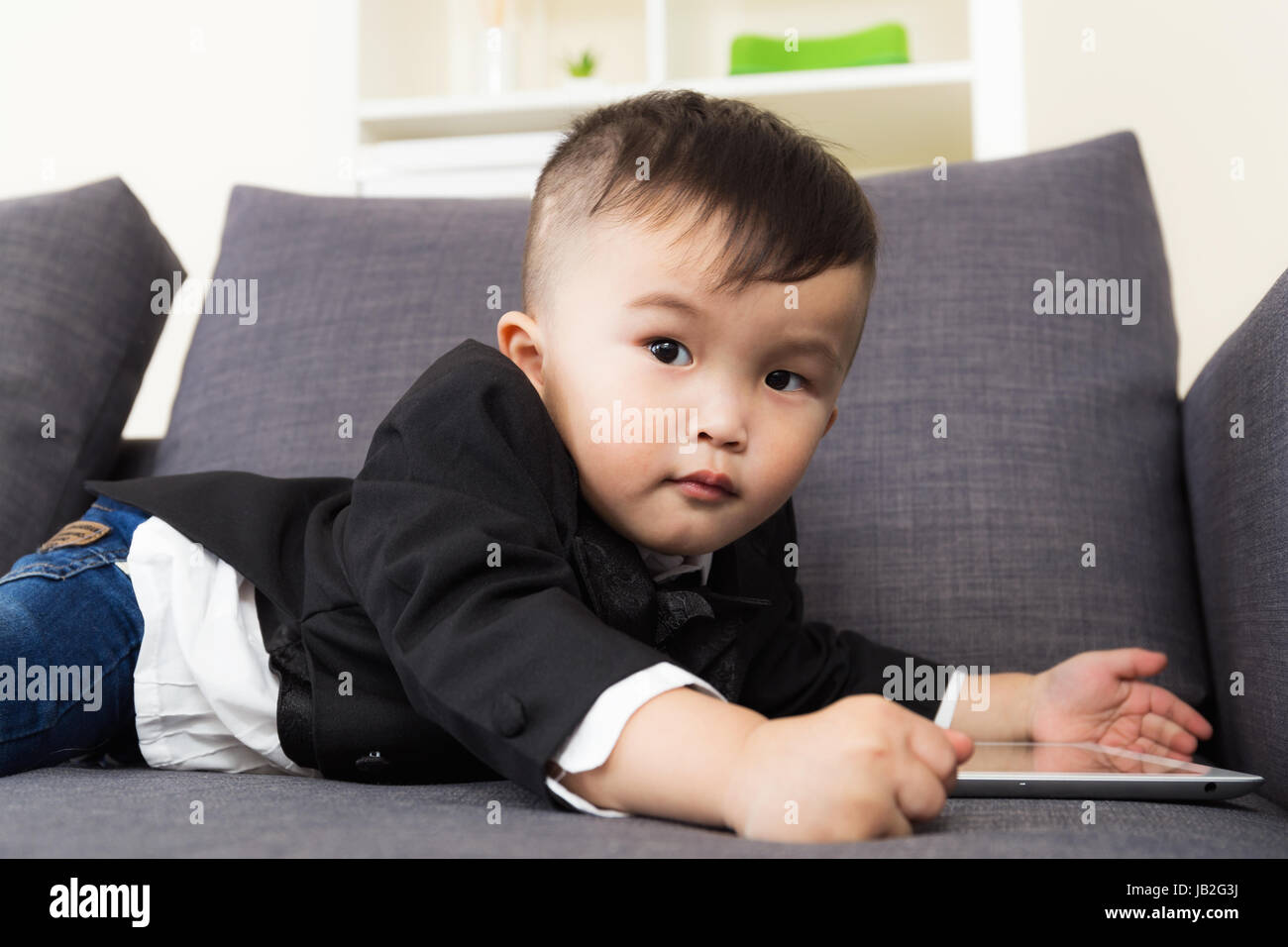 Asian kid using tablet Stock Photo - Alamy