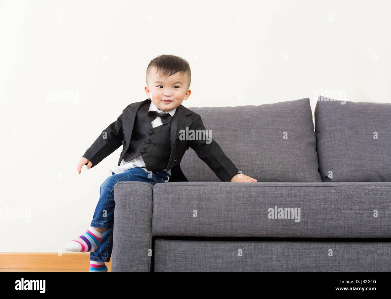 Little boy seating on sofa Stock Photo - Alamy