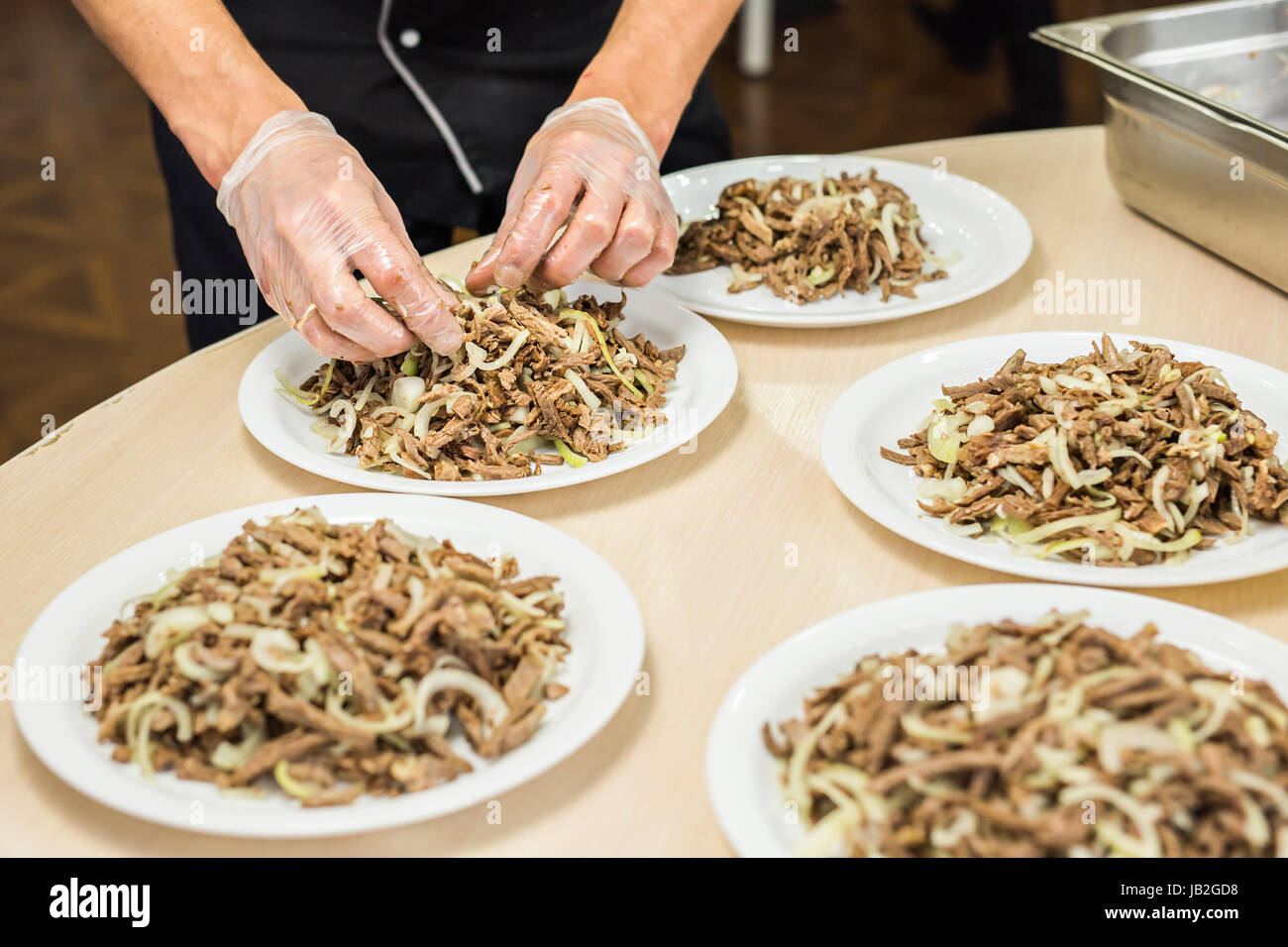 Close-up of chef cooking food kitchen restaurant cutting cook hands ...