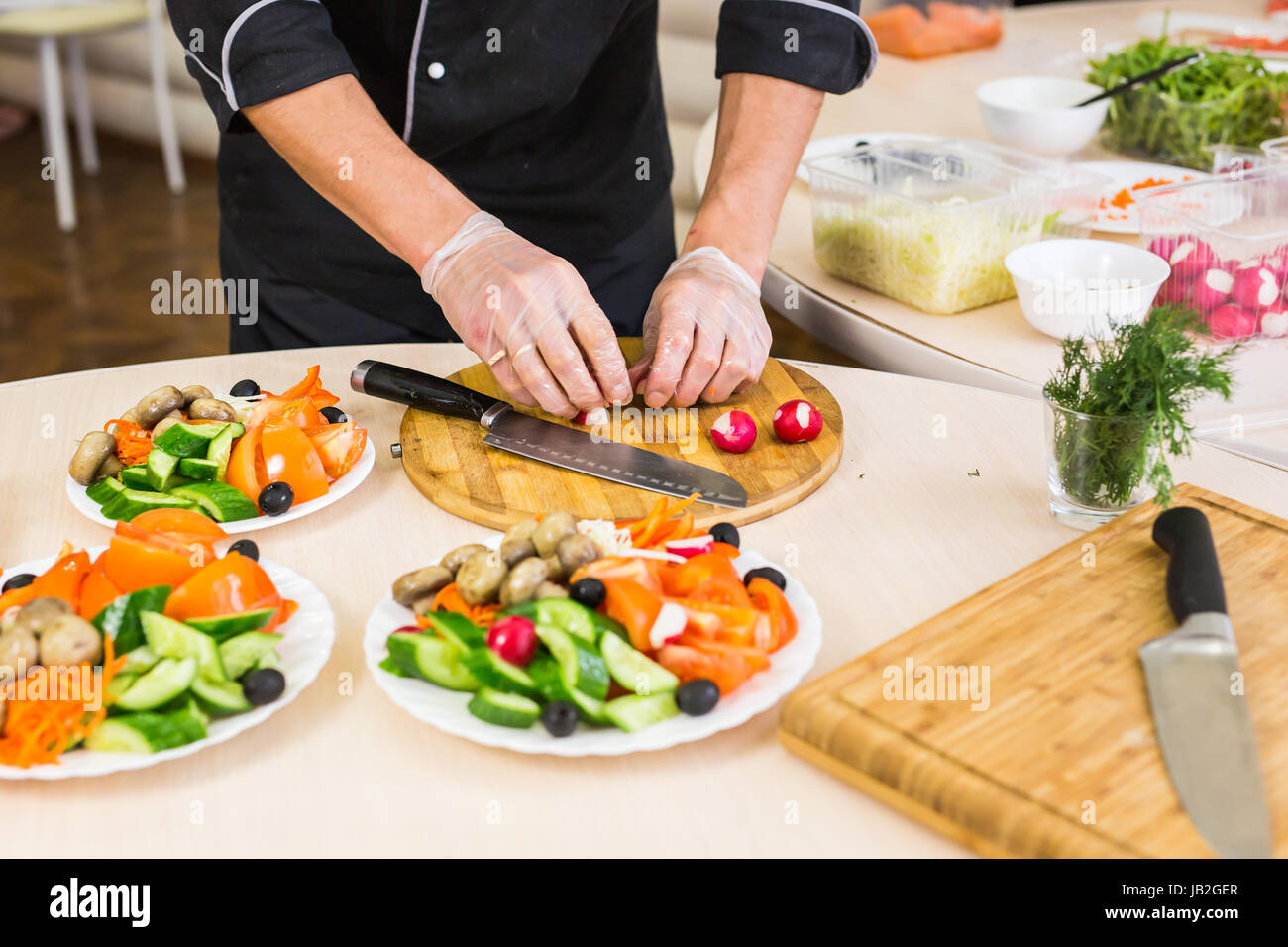 Close-up of chef cooking food kitchen restaurant cutting cook hands ...