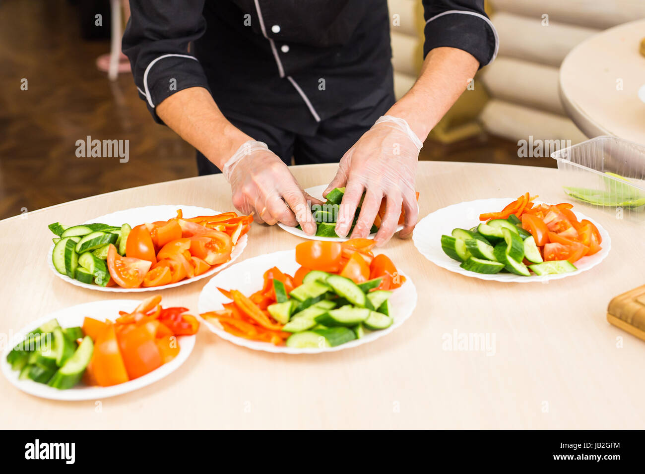 Close-up of chef cooking food kitchen restaurant cutting cook hands ...