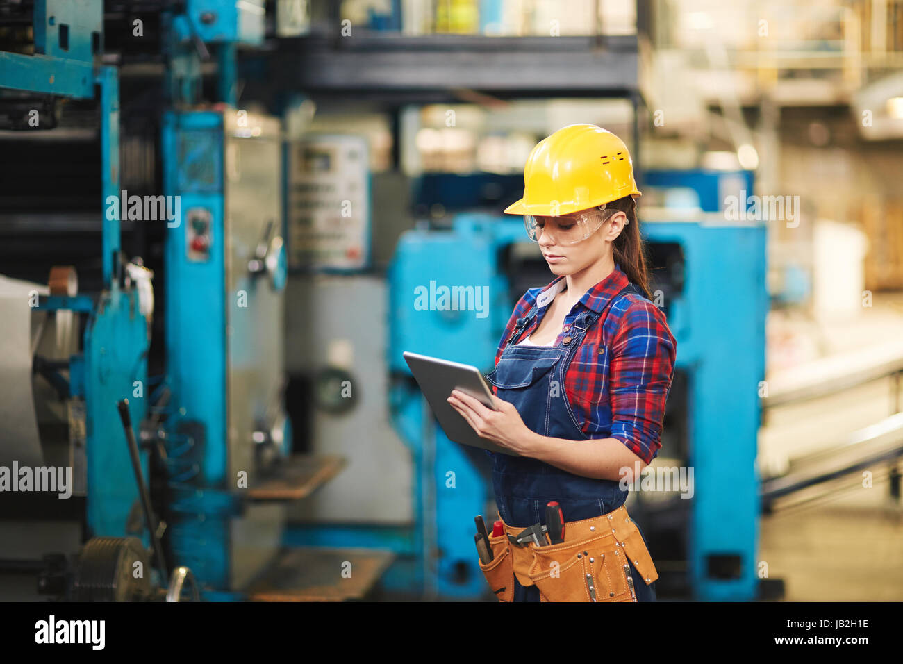 Female Technician Inspecting Machine Stock Photo - Alamy