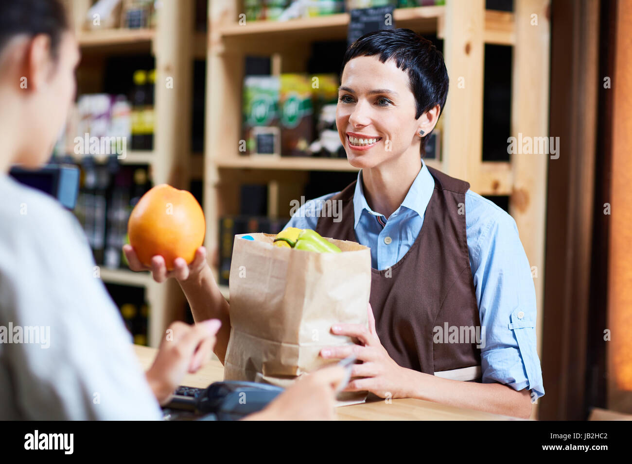 Attending to Customer in Grocery Store Stock Photo - Alamy