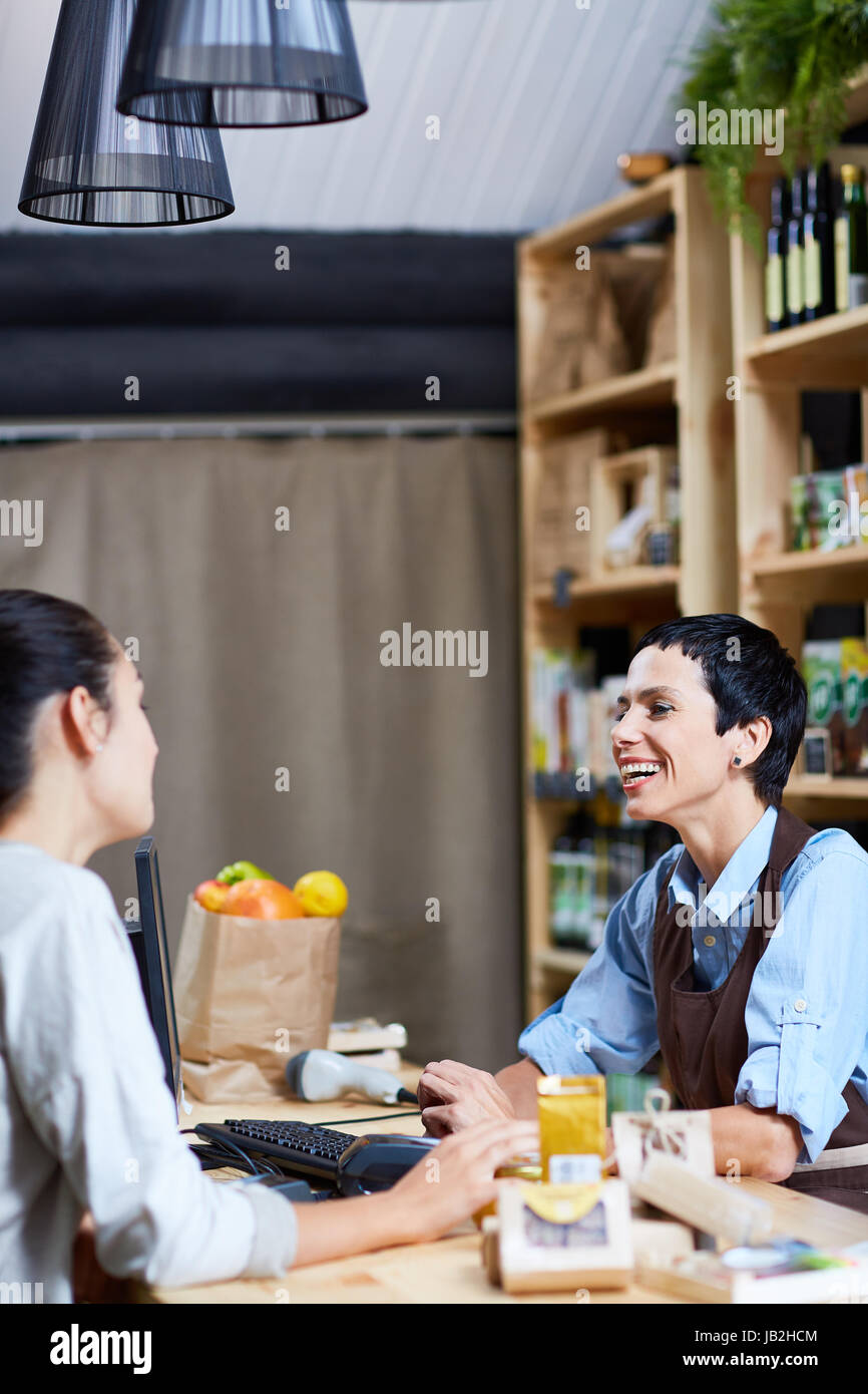 Woman customer talking shop assistant hi-res stock photography and ...