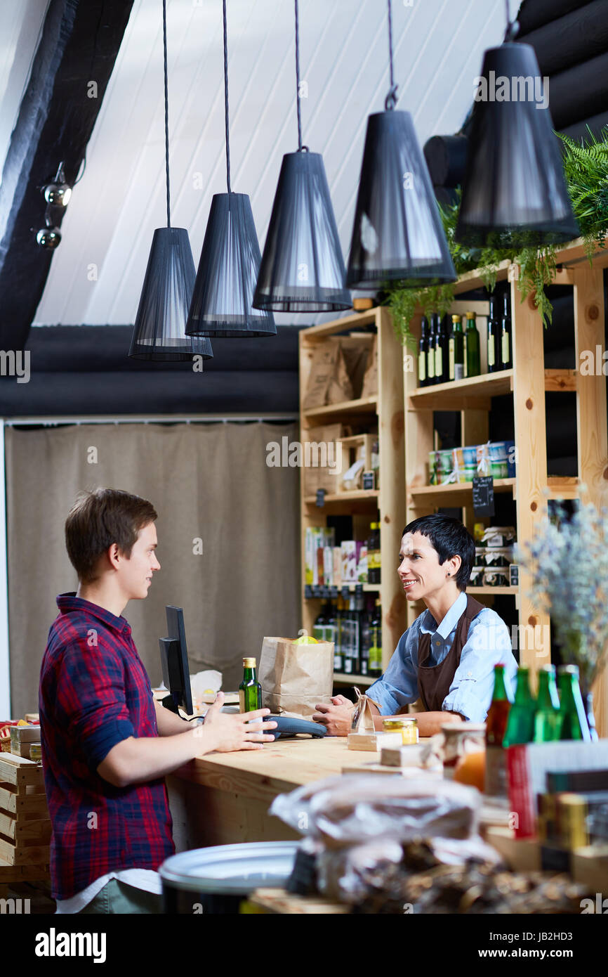 Shop assistant talking customer shopping hi-res stock photography and ...