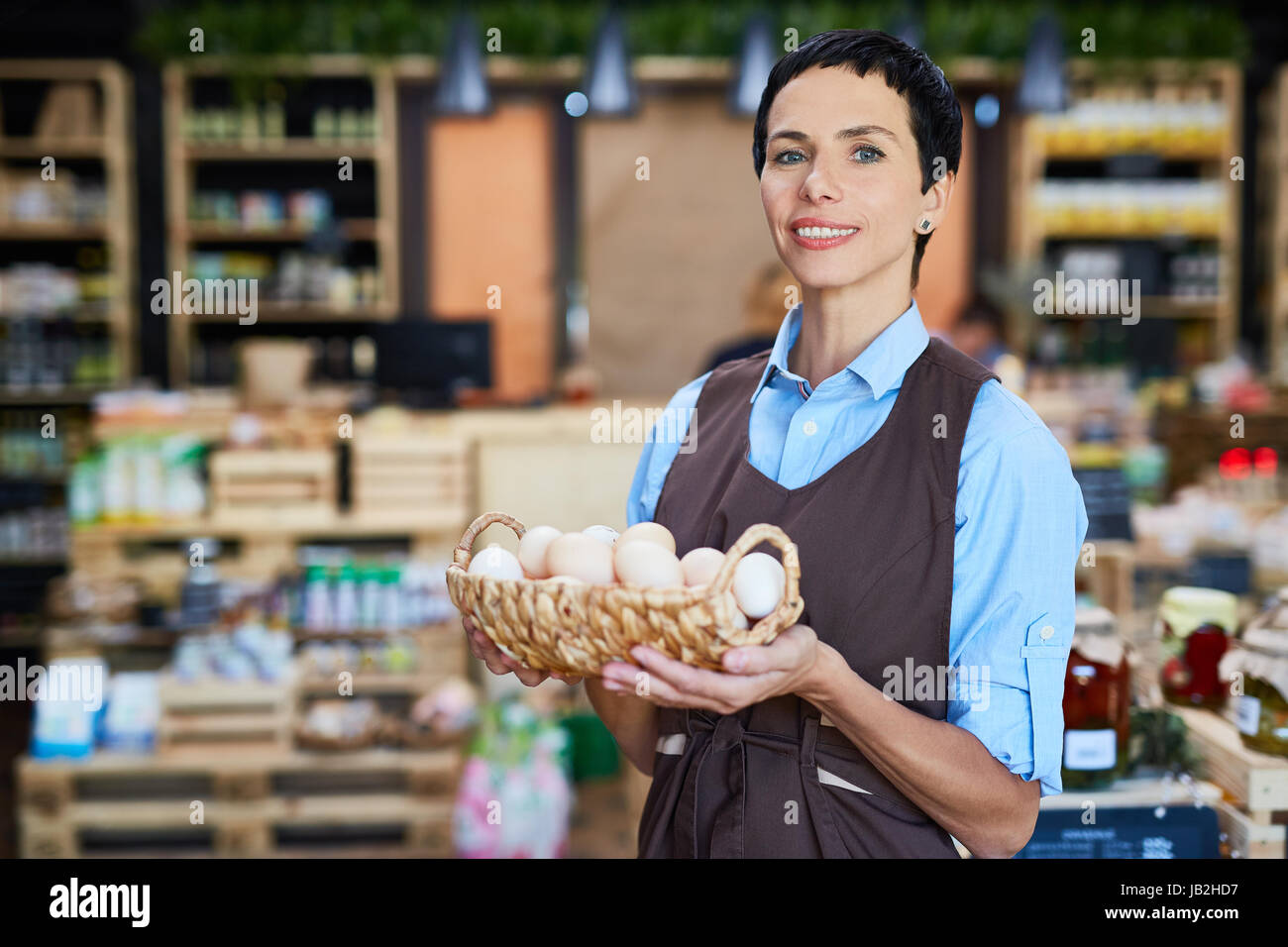 Shop Assistant with Wicker Basket Stock Photo - Alamy