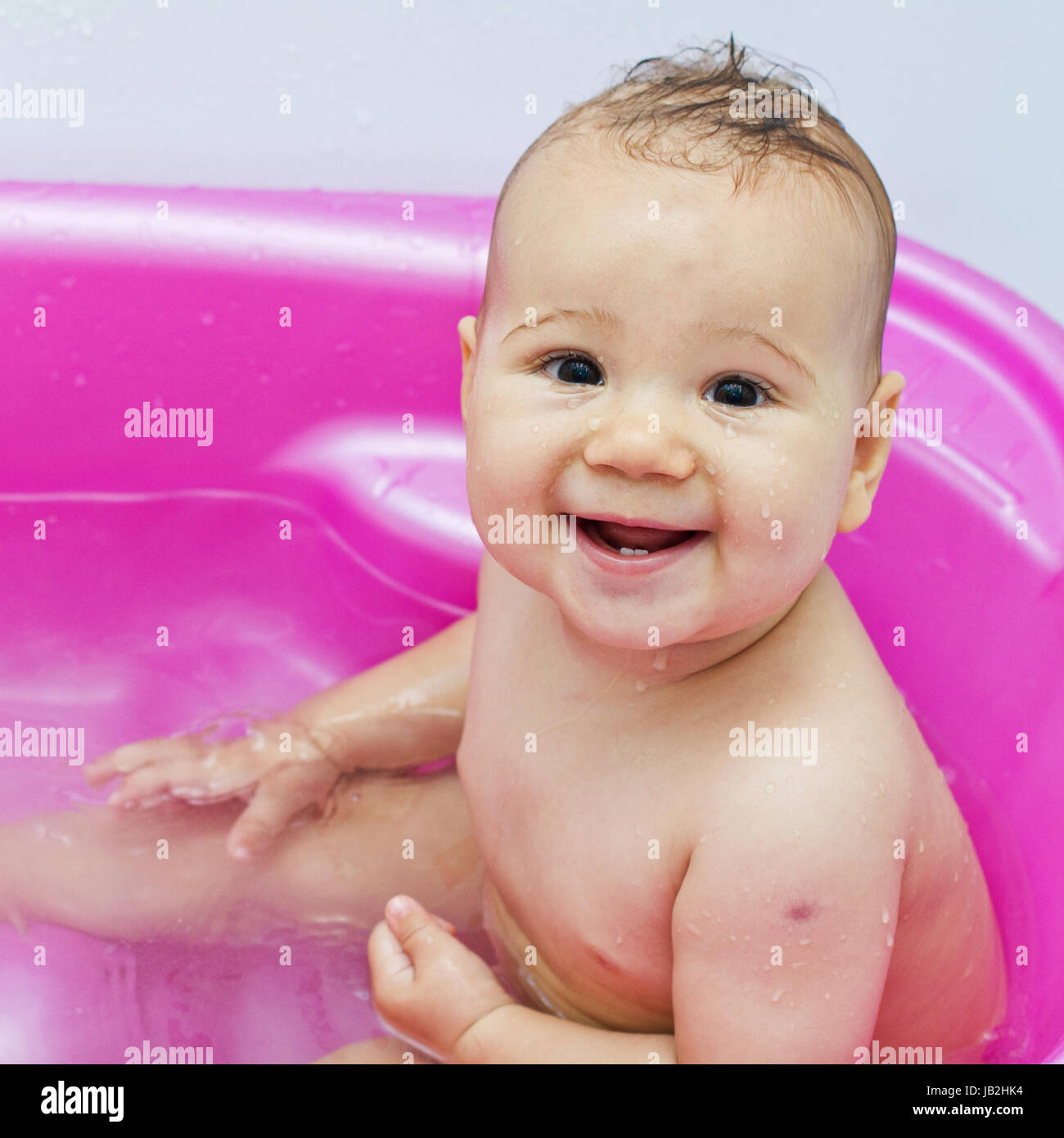 Baby splashing in bathtub hi-res stock photography and images - Alamy
