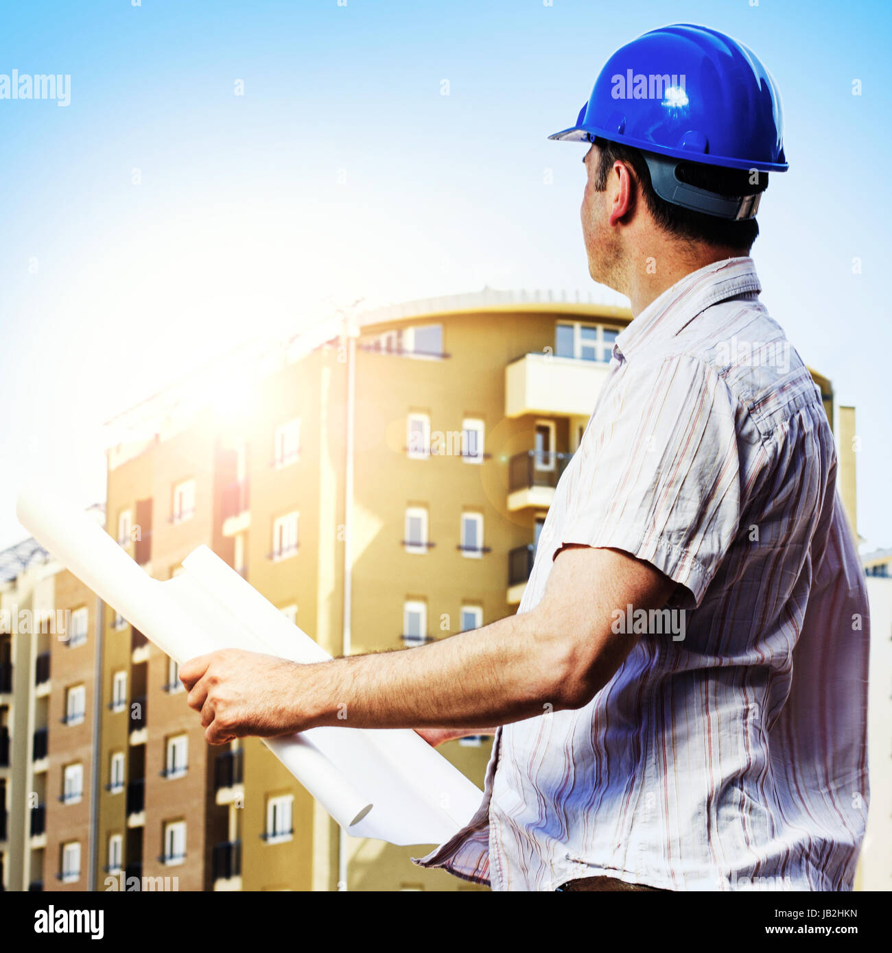 Architect holding blueprint and observe the construction site Stock ...