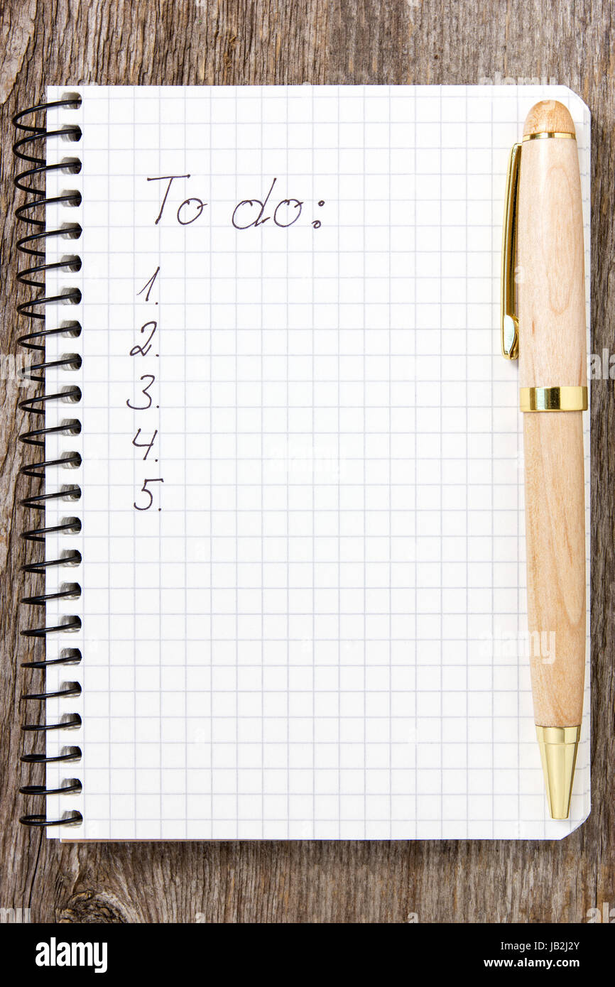 Pen and notepad with a to-do list Stock Photo - Alamy