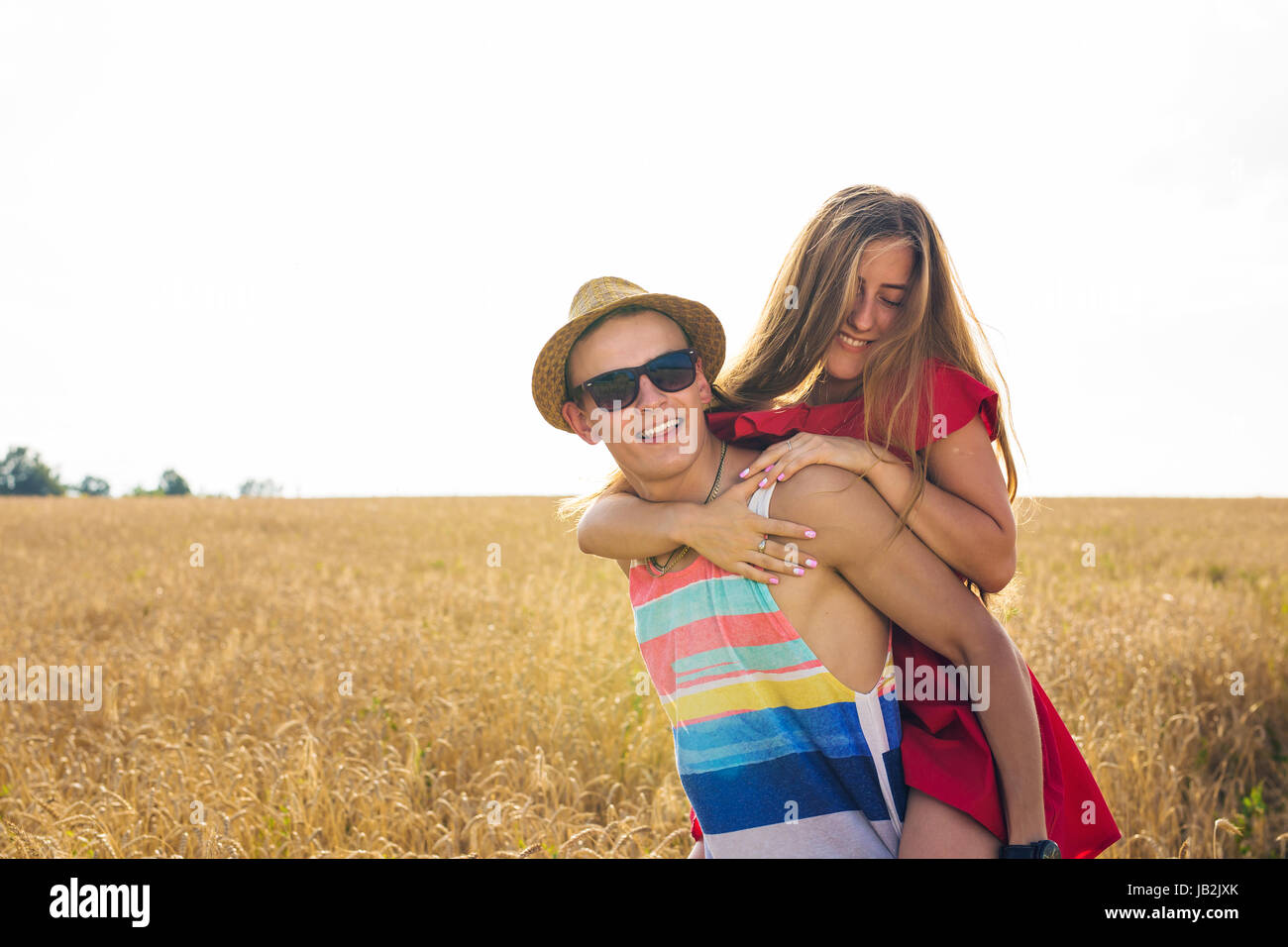 Love Couple Having Piggyback In Summer Field Stock Photo - Alamy