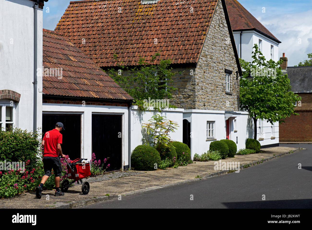 Postman in Poundbury, Dorset, England UK Stock Photo - Alamy